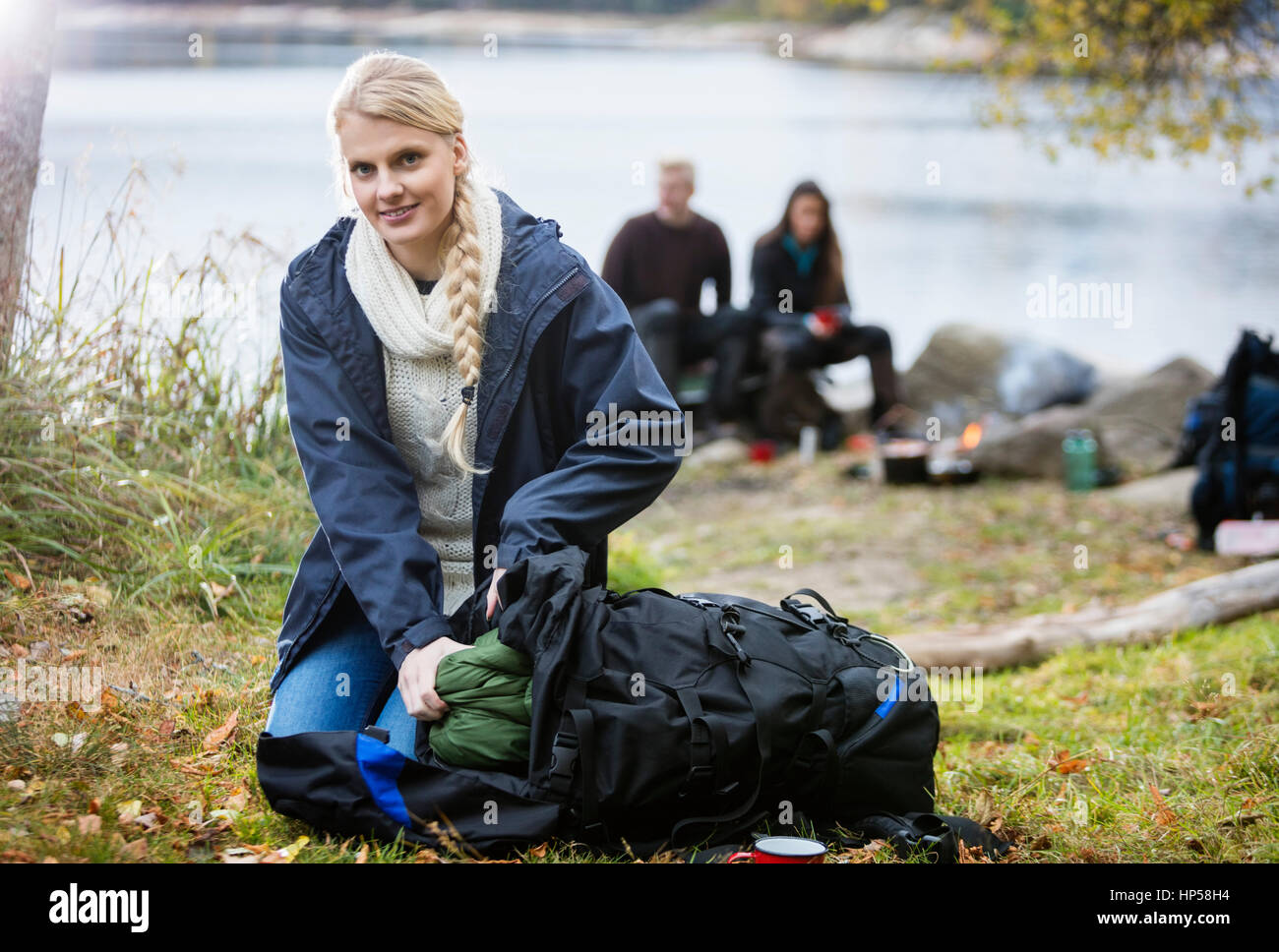 Young Woman Unpacking Backpack At Campsite Stock Photo - Alamy