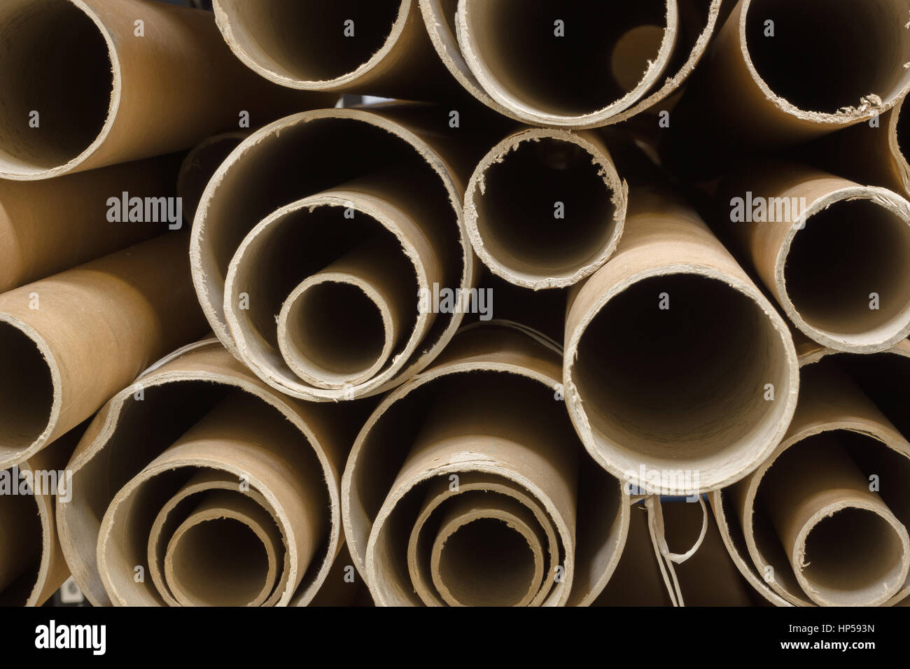 Cardboard postal or mailing tubes in a warehouse storage rack end view ...