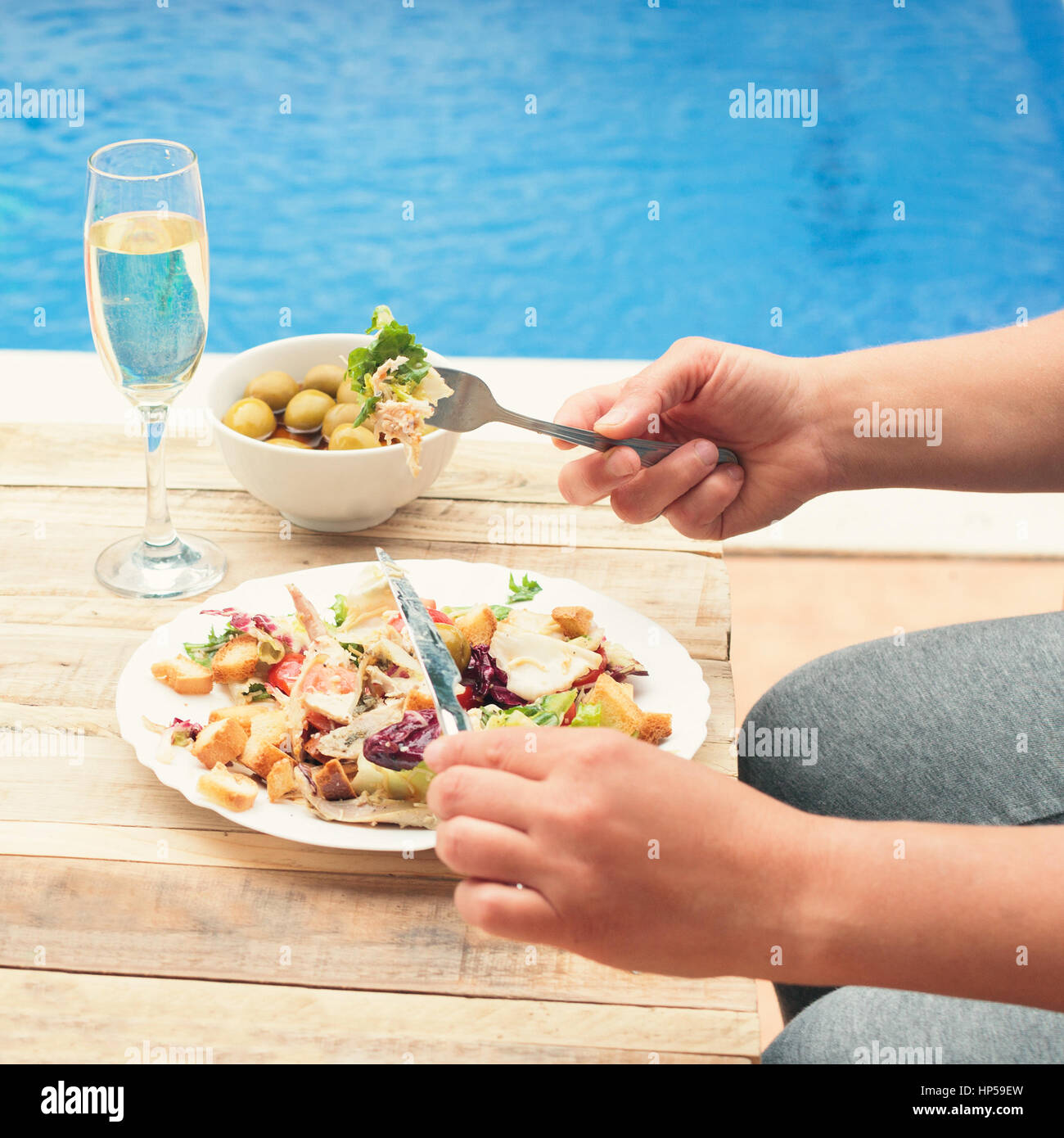 Female having dinner with champagne by the pool outdoor Stock Photo - Alamy