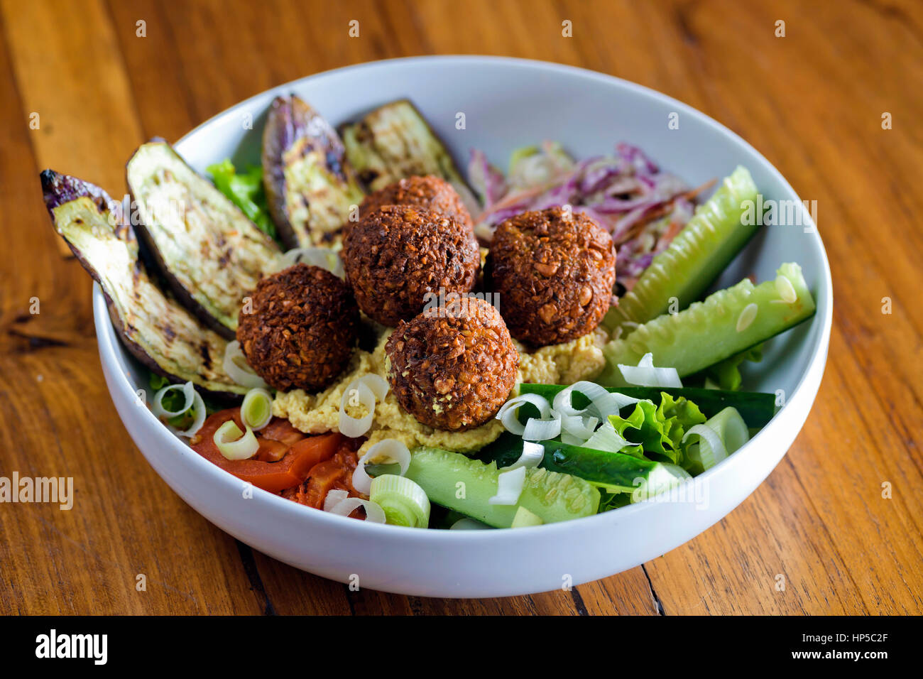 Vegetarian falafels and vegetables in bowl on white wood Stock Photo ...