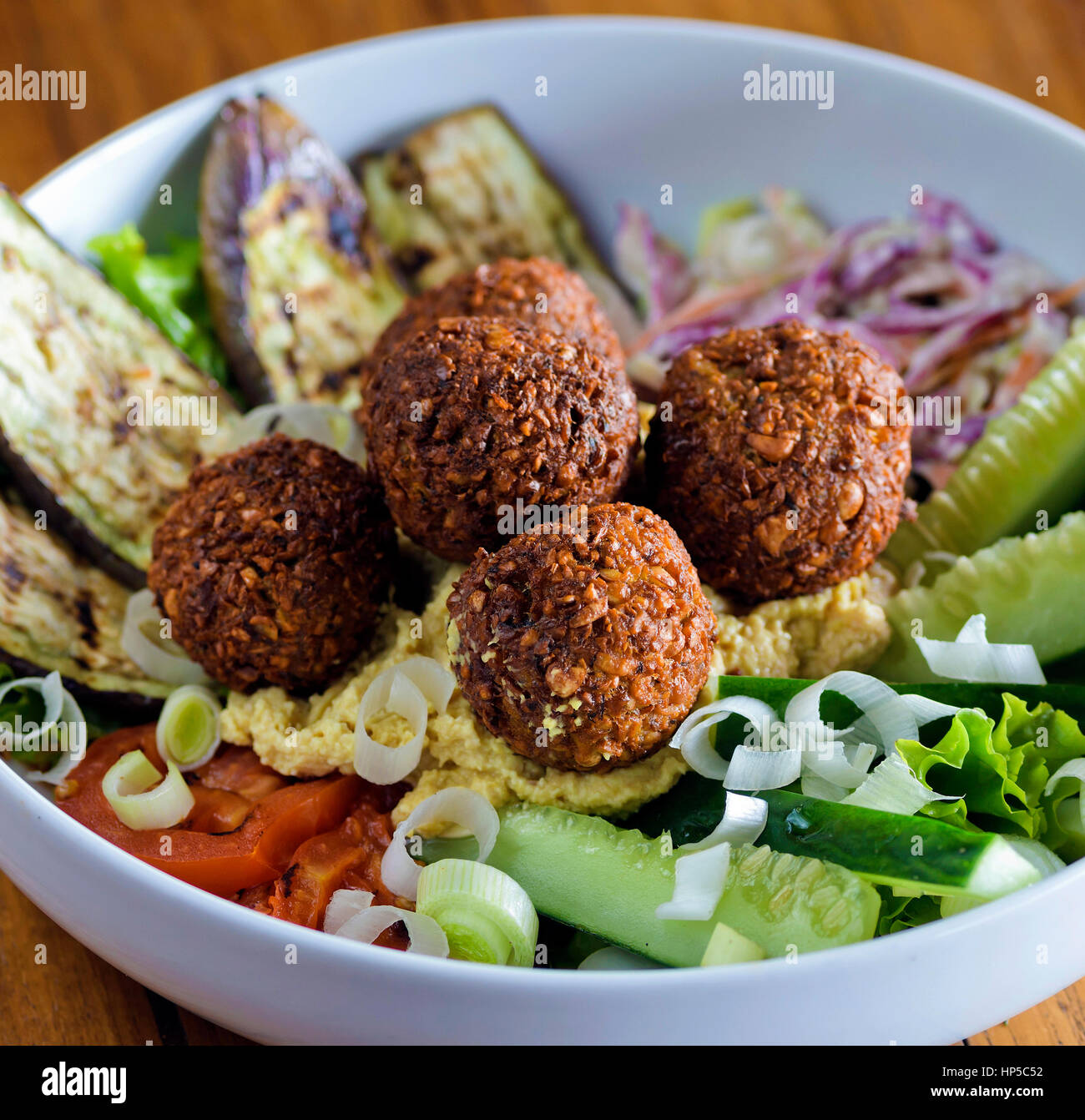 Vegetarian falafels and vegetables in bowl on white wood Stock Photo ...