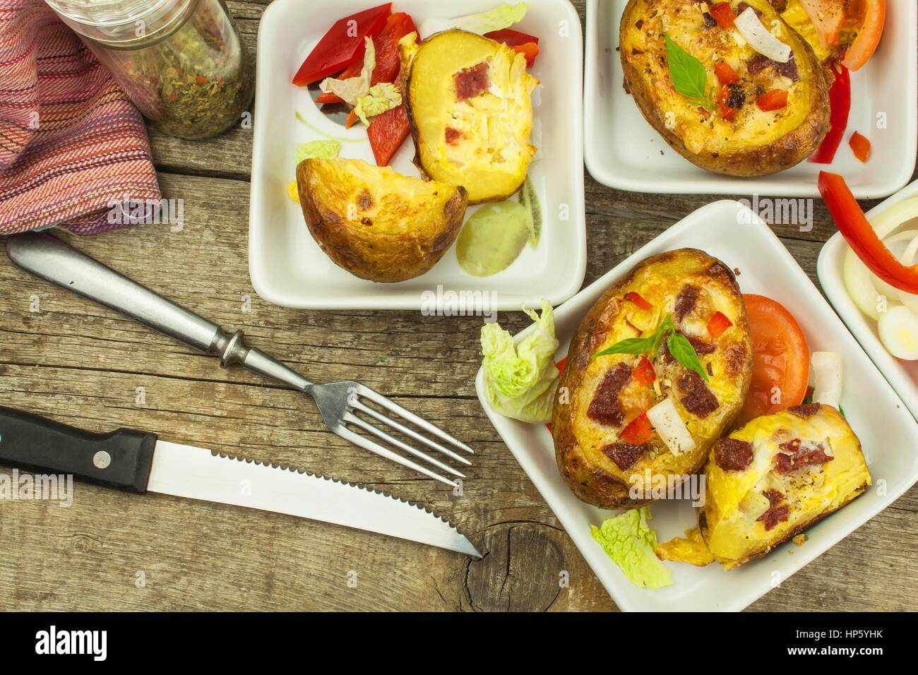 Stuffed baked potatoes on a wooden table. Healthy food. Homework dinner ...