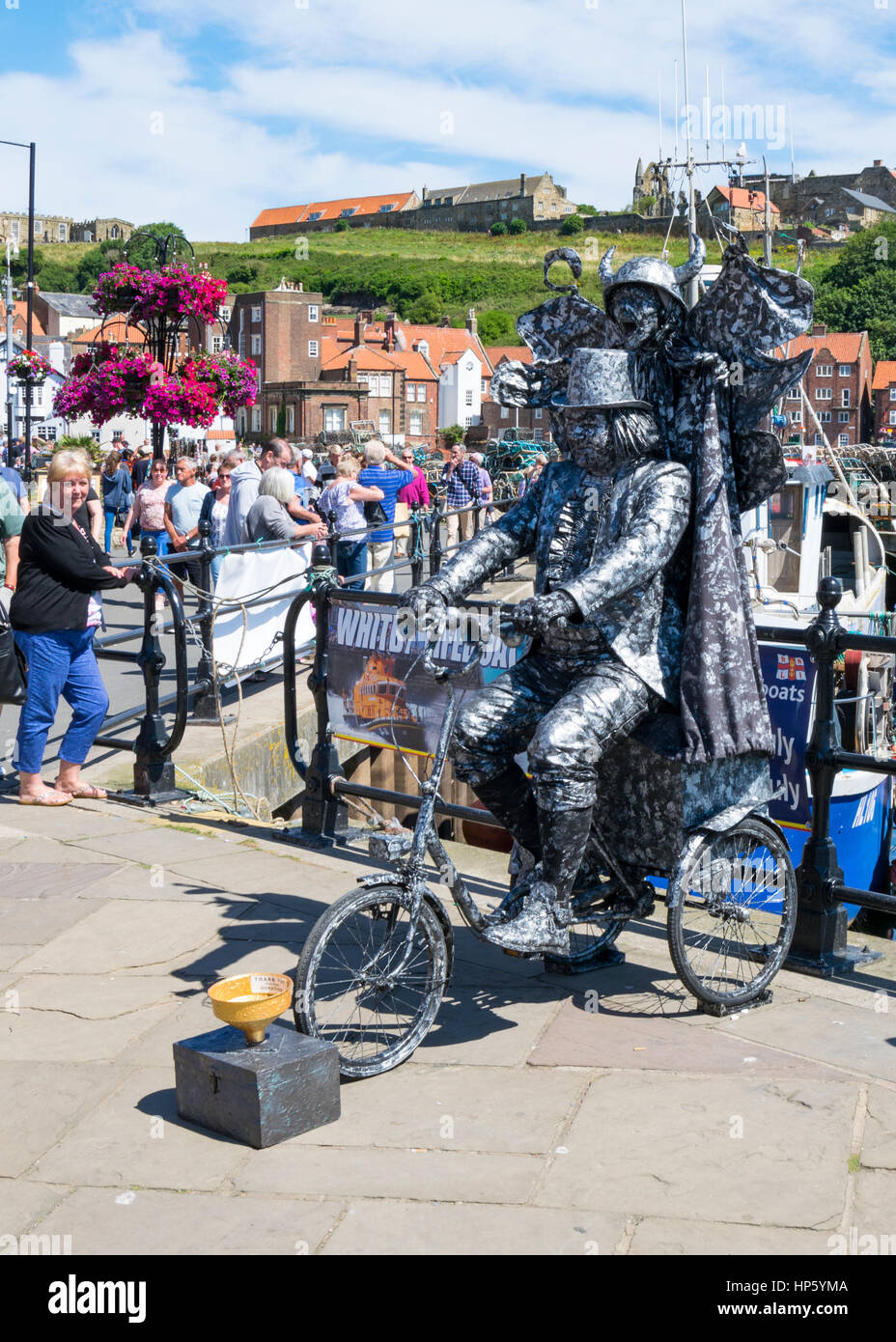 A living statue performer on a bicycle in Whitby, UK Stock Photo - Alamy