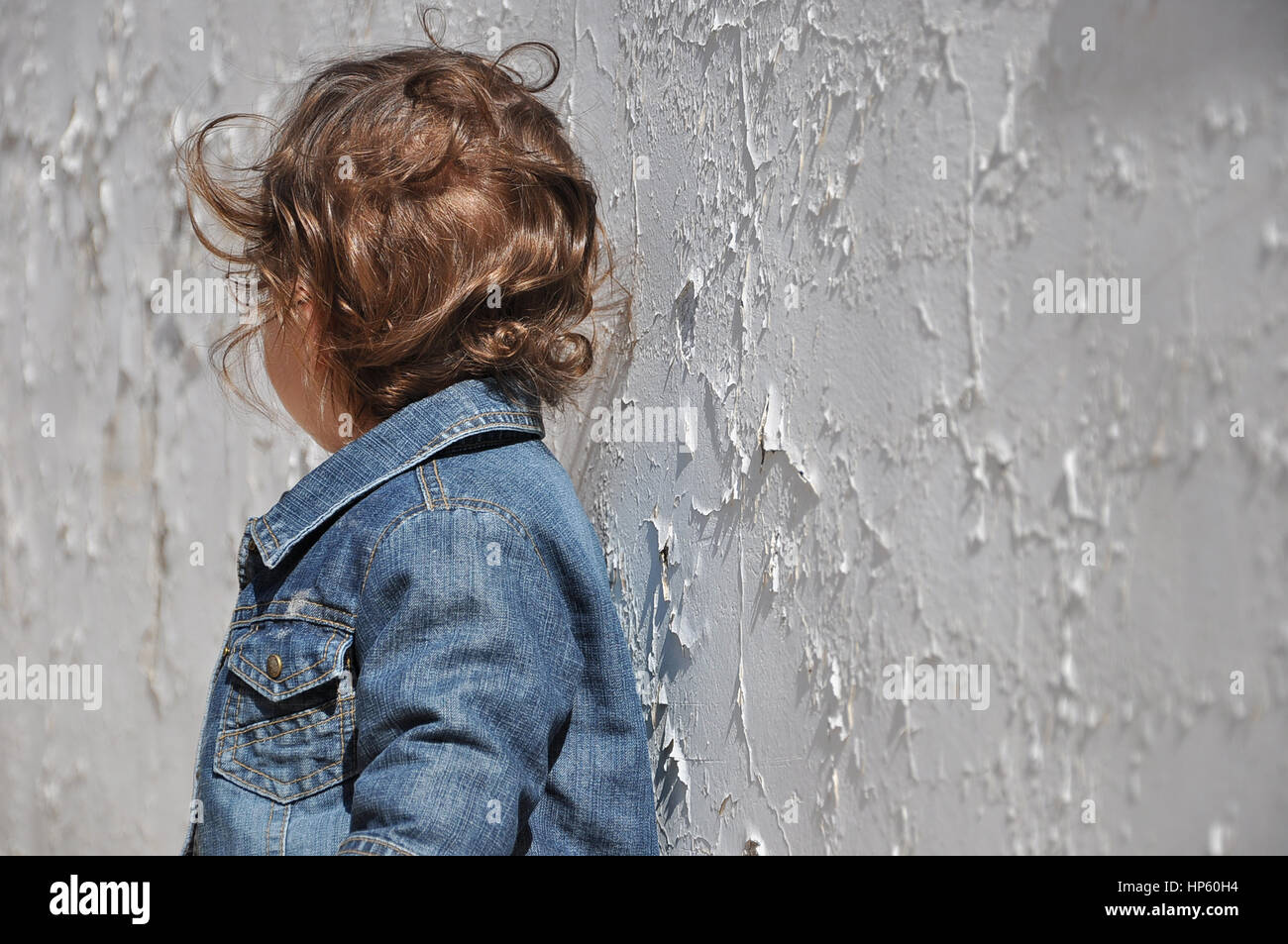 Little baby todller standing in front of a white background wall Stock ...
