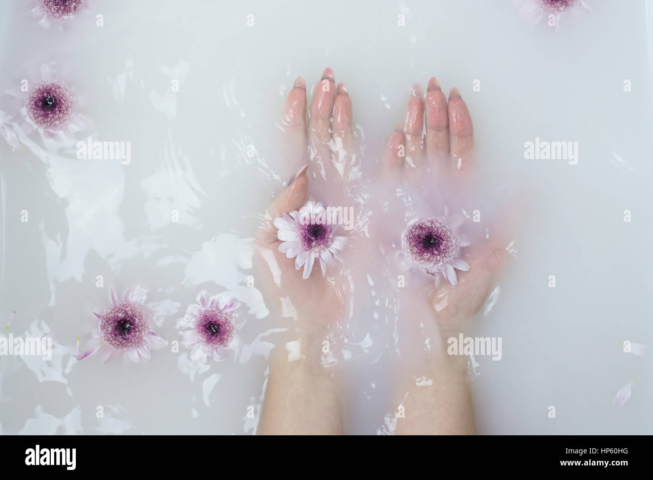Woman's hand holding flowers under water. Spa treatment Stock Photo - Alamy