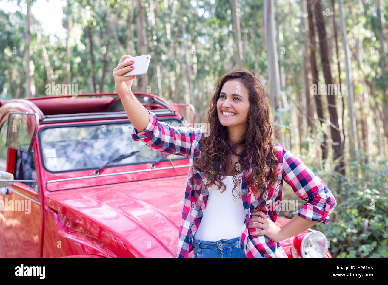 Young woman talking a selfie celebrating the start of a roadtrip Stock ...
