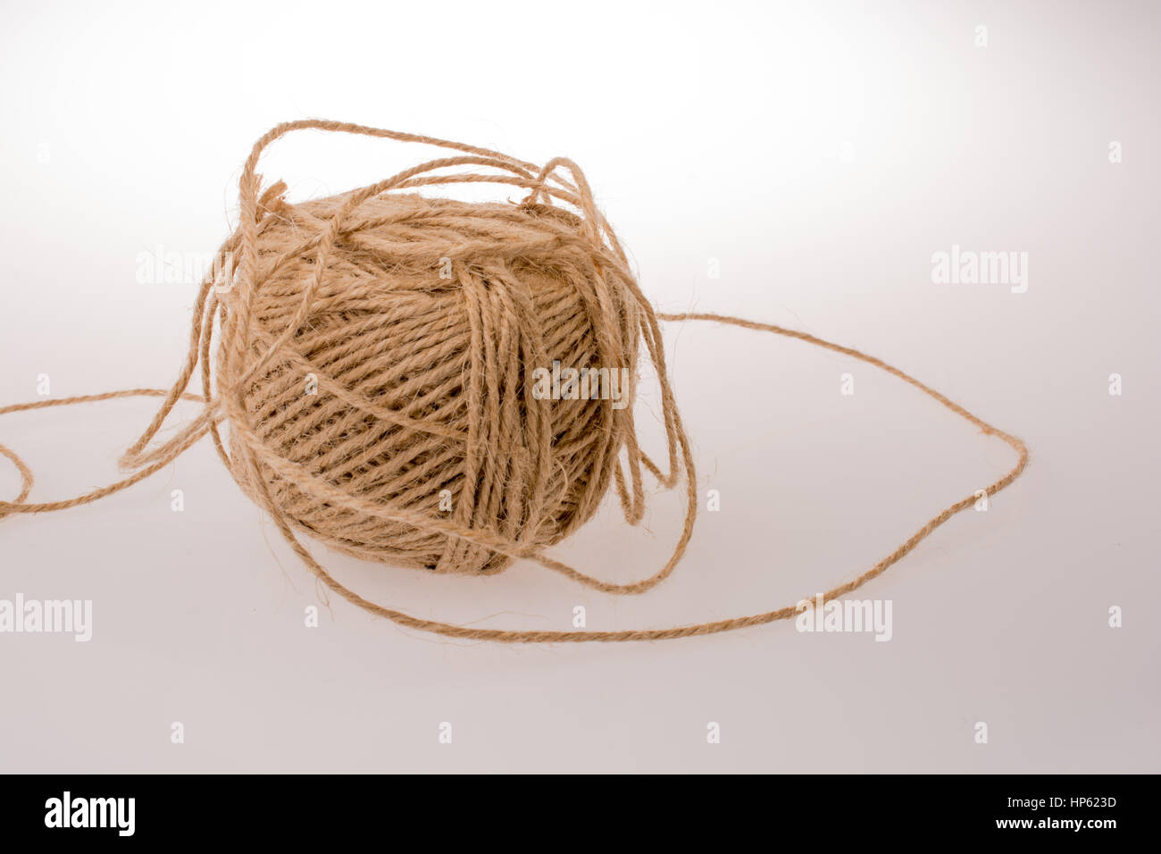 Roll of brown color linen string on a white background Stock Photo - Alamy