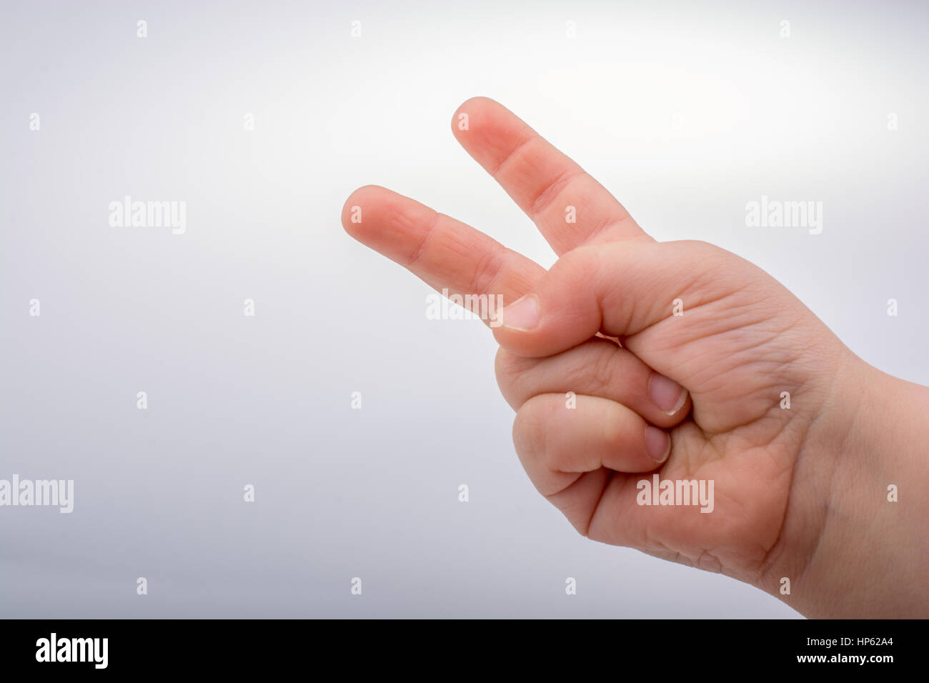 Kid's hand making a number two gesture Stock Photo - Alamy