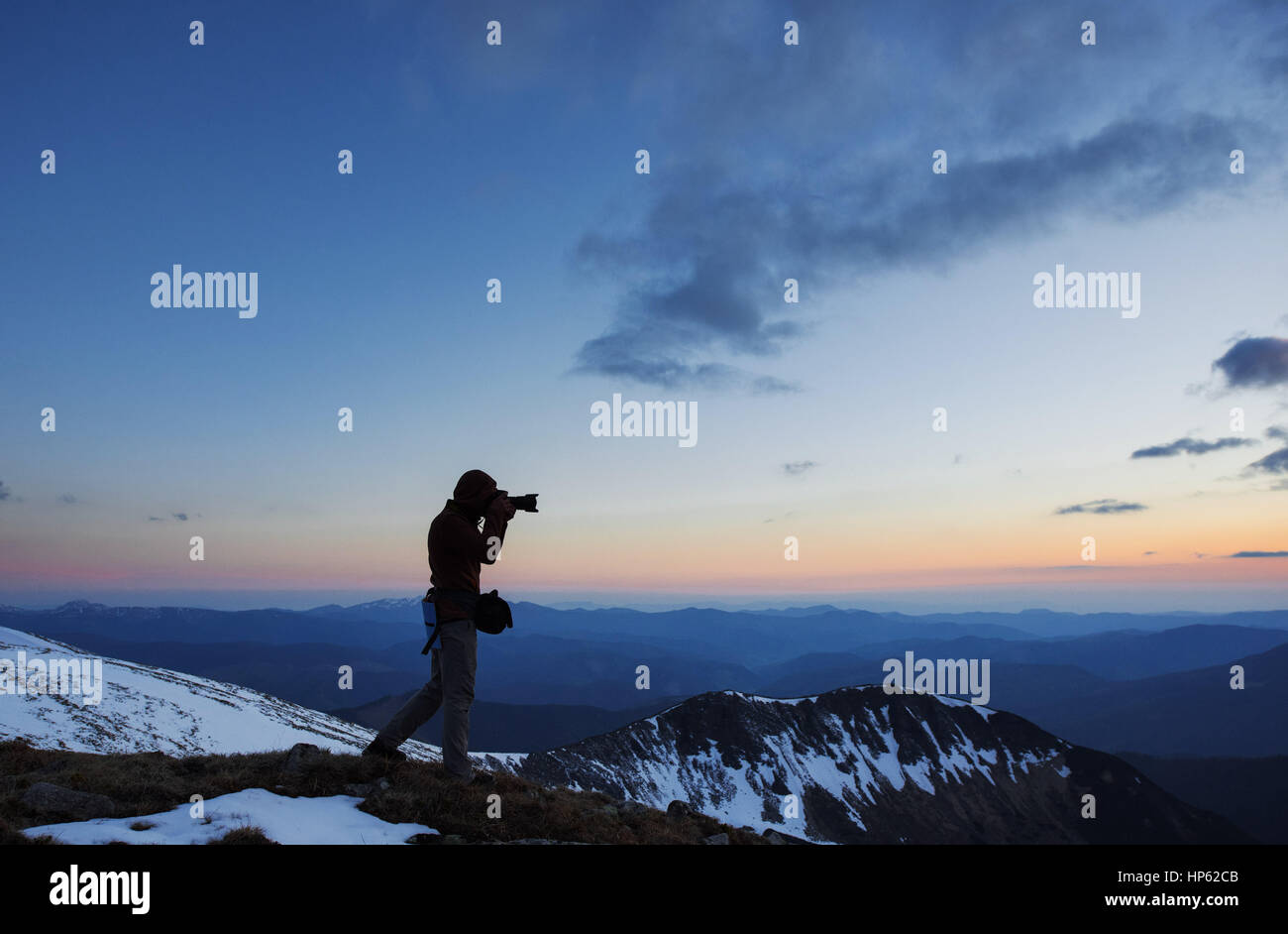 tourist looks at the landscape. Beautiful sunset Stock Photo - Alamy
