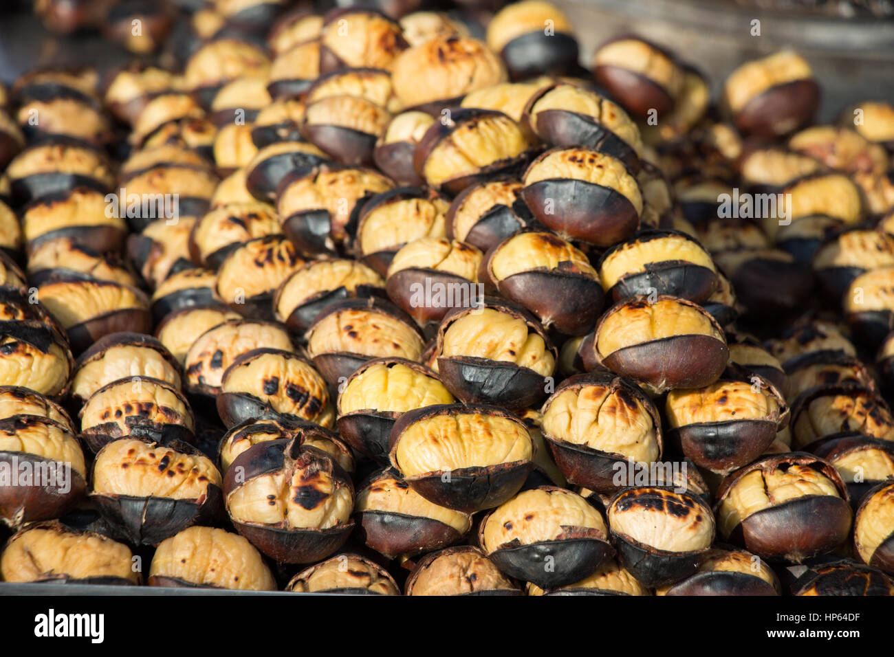 Organic brown chestnuts roasted over a hot fire Stock Photo - Alamy