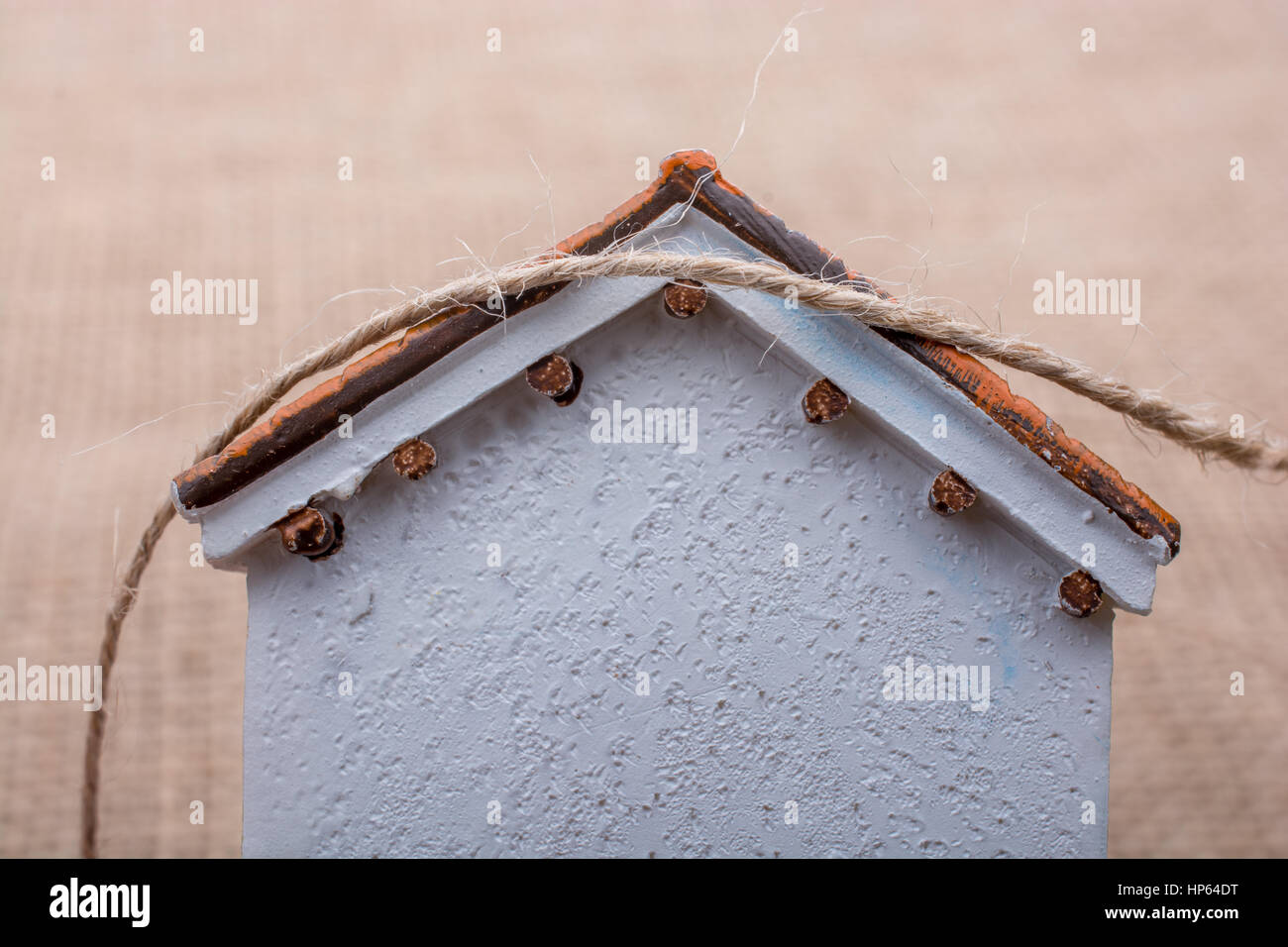 Thread wrapped around a model house on a brown background Stock Photo ...
