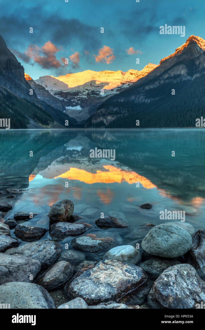 the sun rising and illuminating victoria glacier with a perfect ...