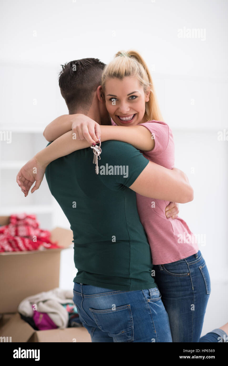 excited happy young couple looking forward to moving into a new home ...