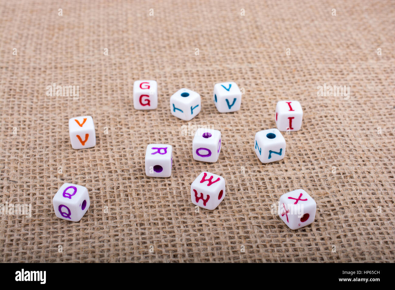 Colorful alphabet letter cubes on a linen canvas Stock Photo - Alamy