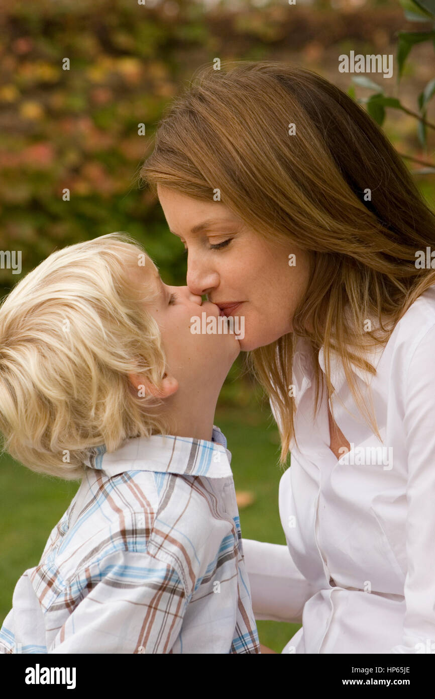 Happy mother hugging her son outside Stock Photo - Alamy
