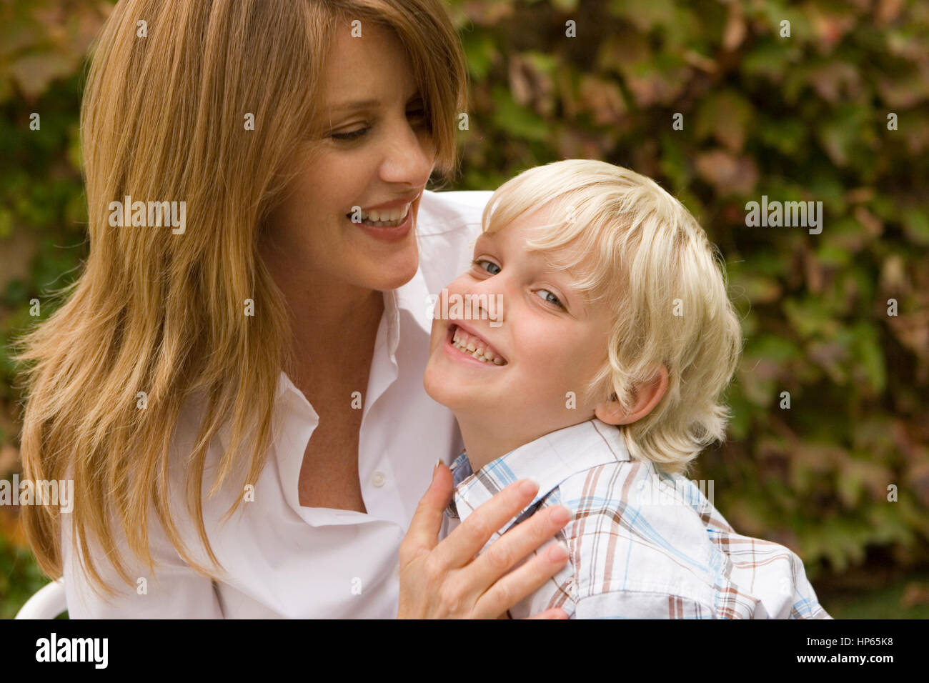 Happy mother hugging her son outside Stock Photo - Alamy