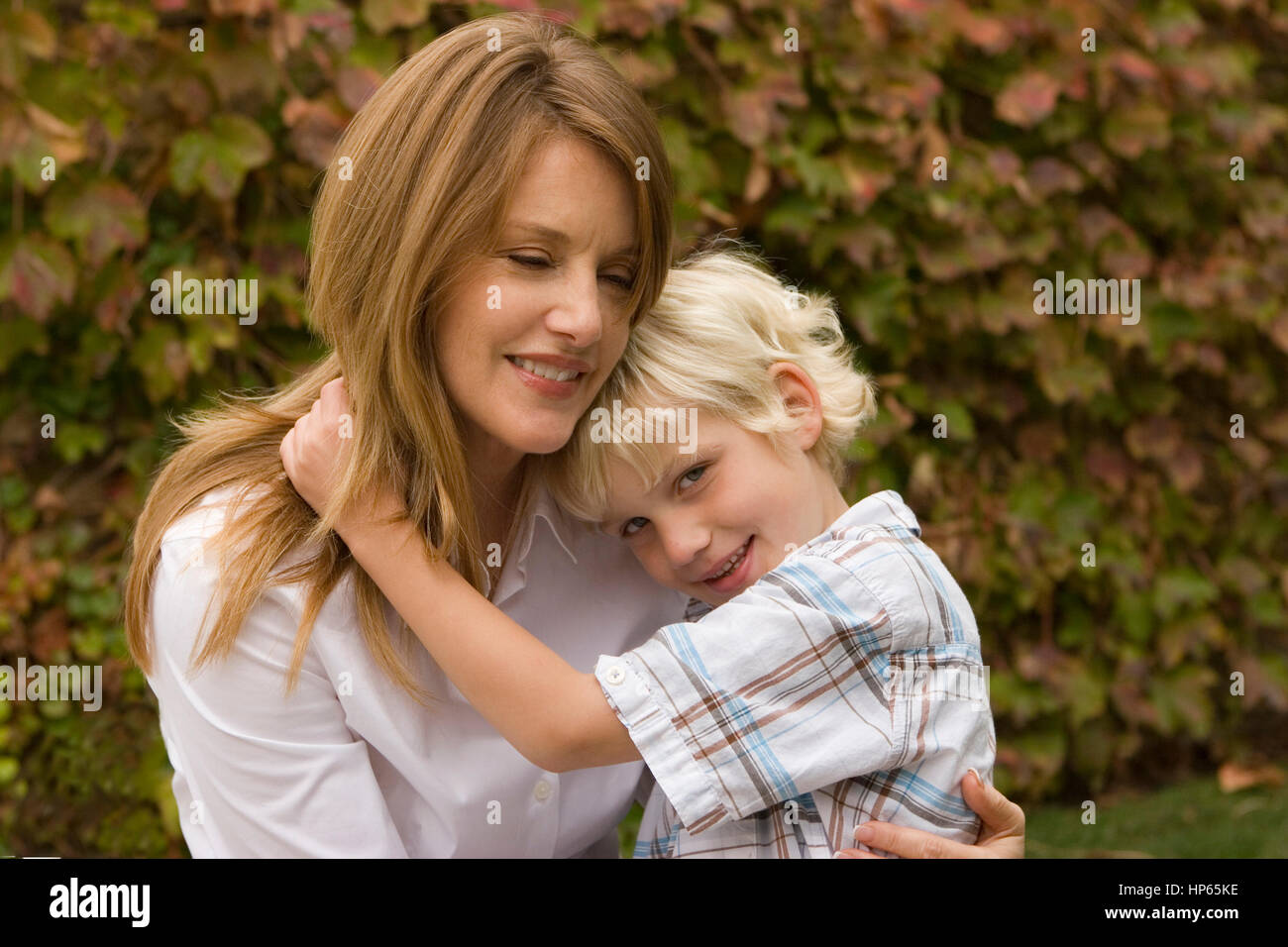 Happy mother hugging her son outside Stock Photo - Alamy