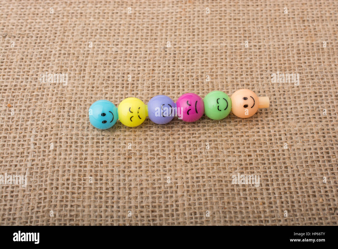Colorful beads of face various color placed on linen canvas Stock Photo ...
