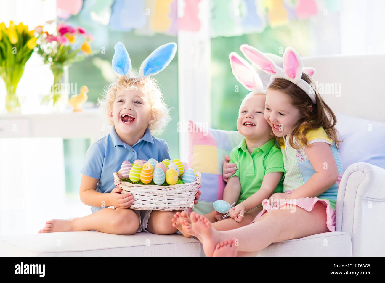 Kids celebrate Easter. Family, happy little girl, boy and baby in bunny ...