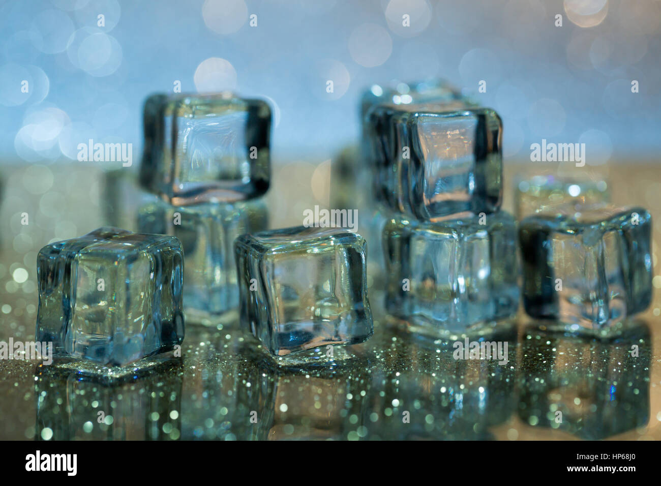 Group of melting ice cubes on glass table Stock Photo - Alamy
