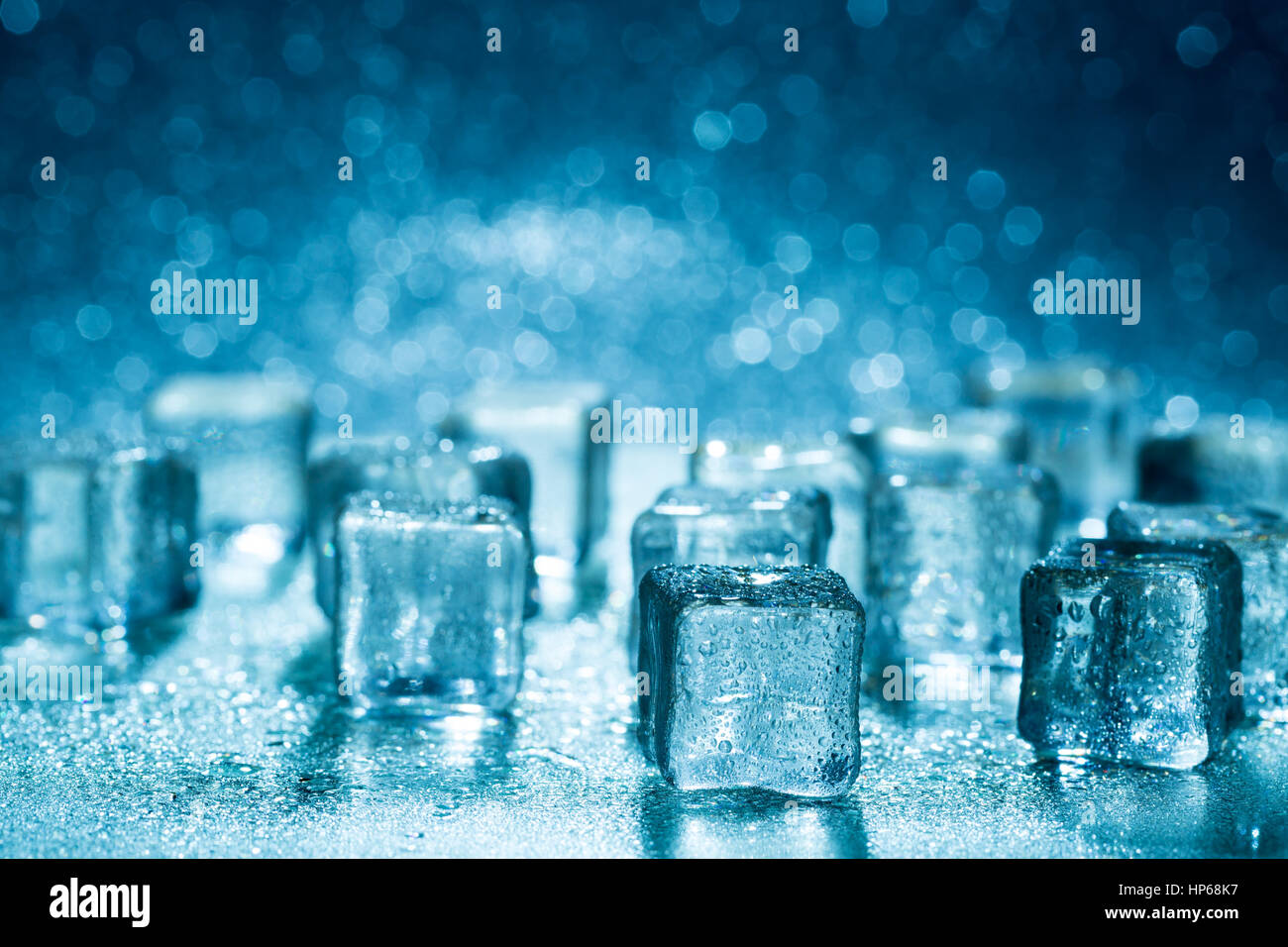 Group of melting ice cubes on glass table Stock Photo - Alamy