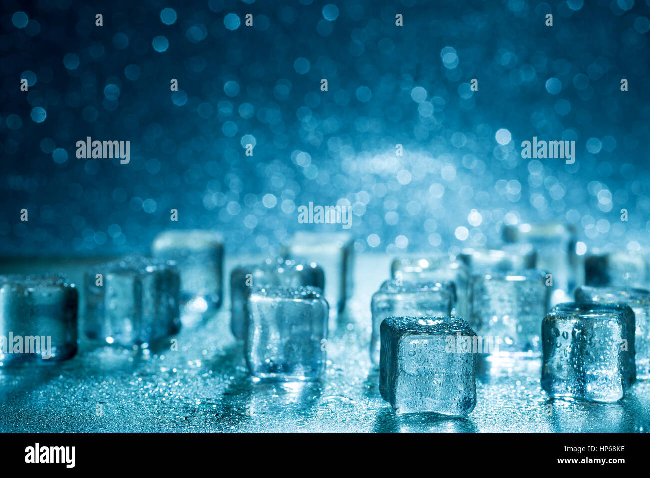 Group of melting ice cubes on glass table Stock Photo - Alamy