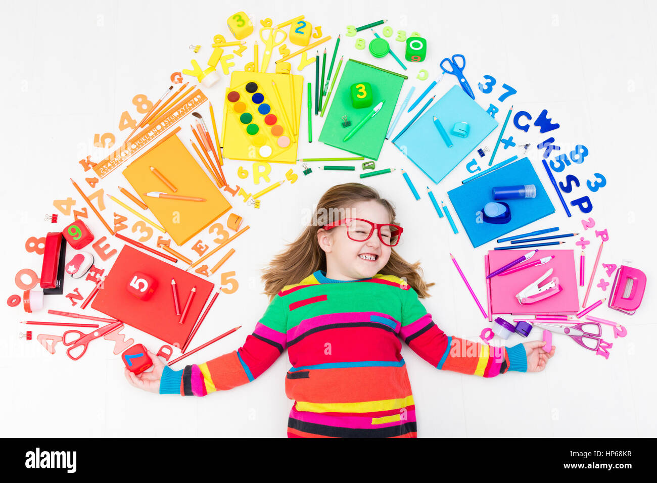 Little girl with school supplies, books, drawing and painting tools and ...