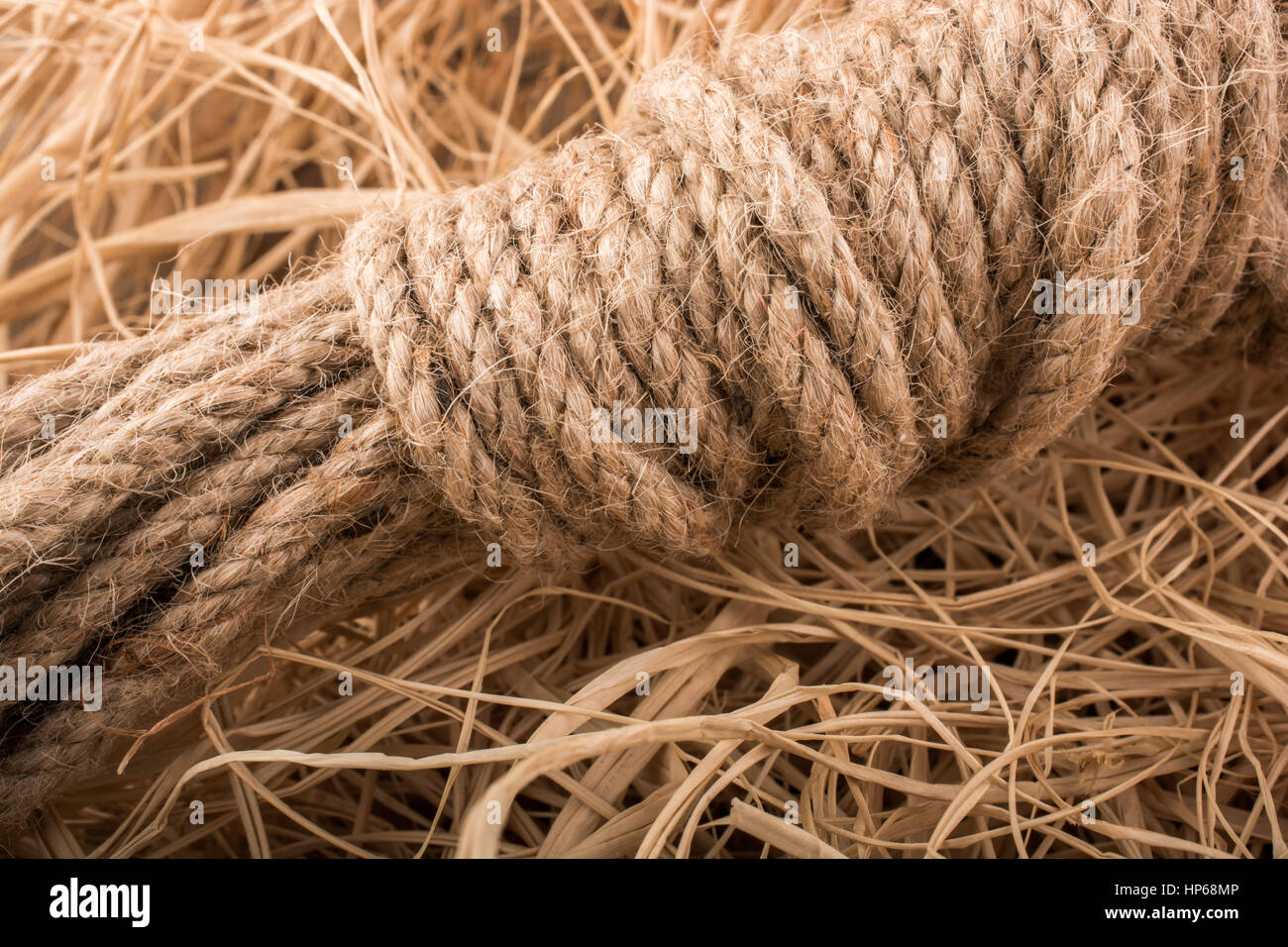 Bundle of linen rope in a straw background Stock Photo - Alamy
