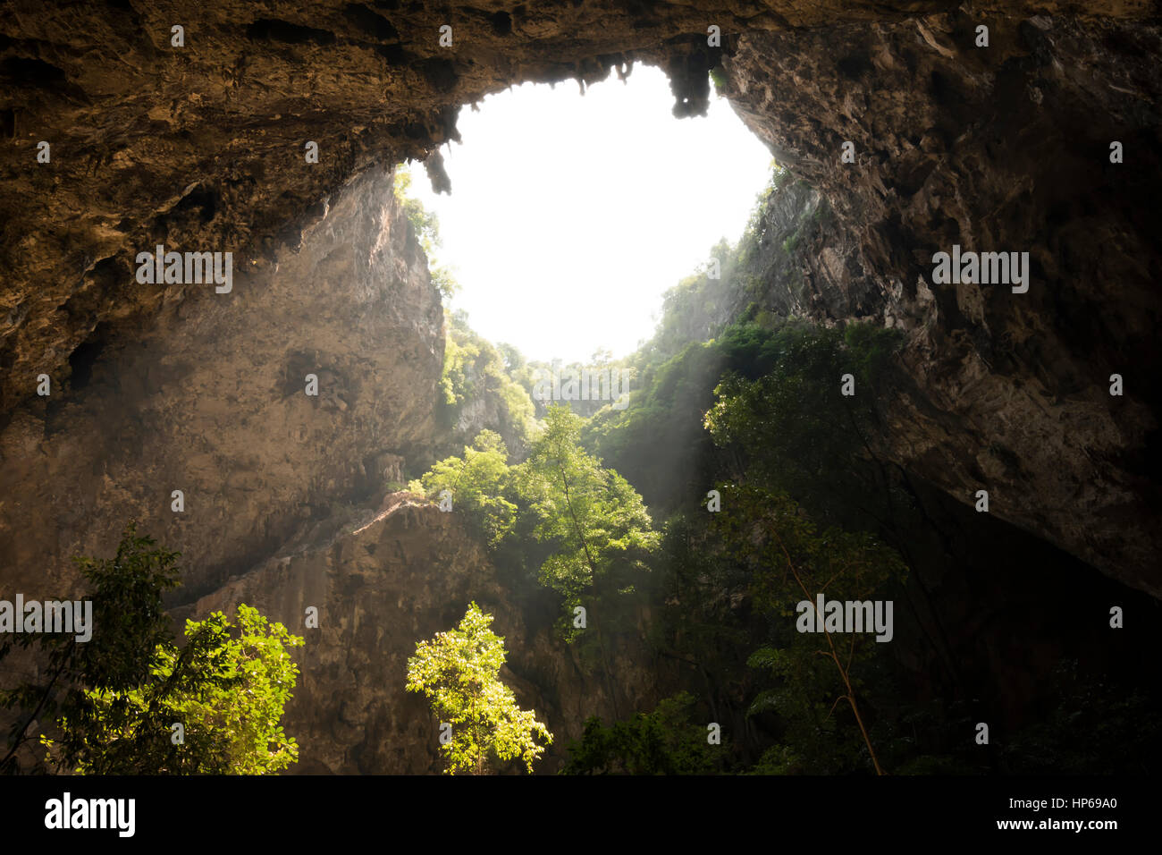 Sunlight through a cave hole in Thailand Stock Photo - Alamy