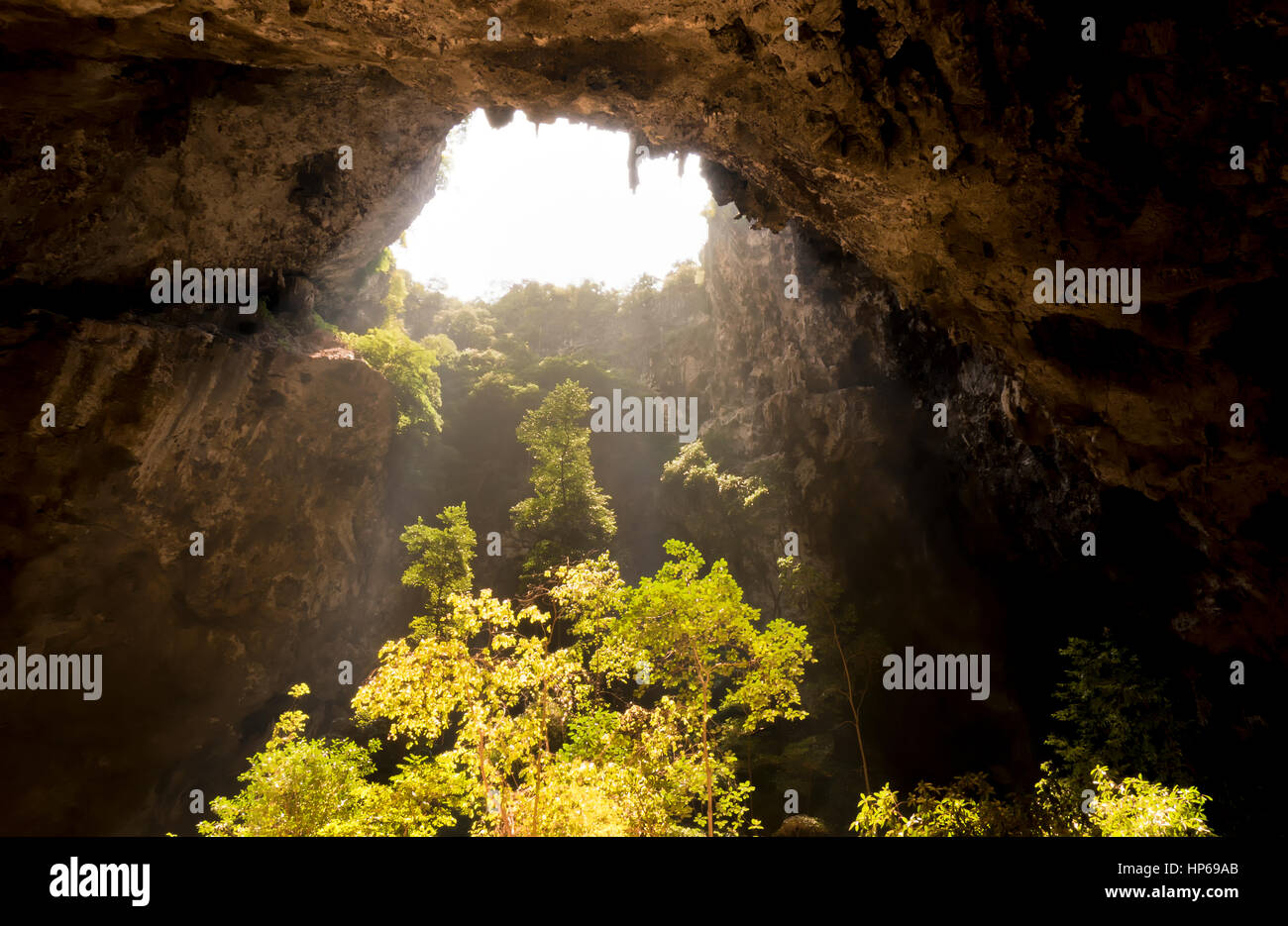 Sunlight through a cave hole in Thailand Stock Photo - Alamy