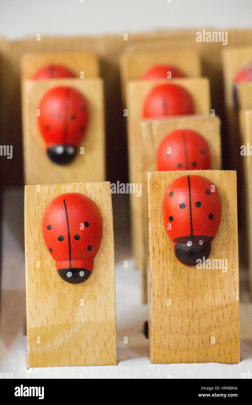 Fake red ladybugs made of wooden material Stock Photo - Alamy