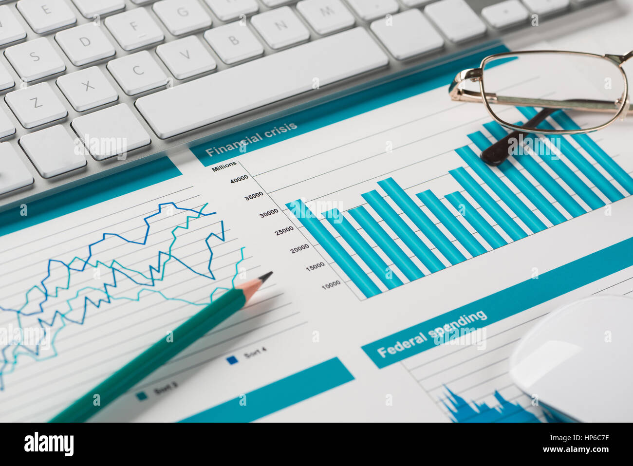 Business workplace with keyboard mouse and papers with graphs and ...