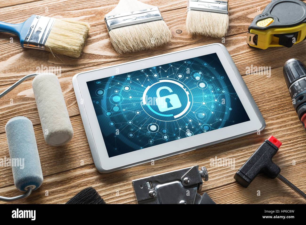 Tablet pc with security concept on screen and industrial tools around ...
