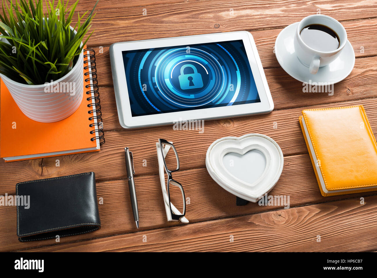 Business workplace with office stuff and tablet with padlock icons on ...