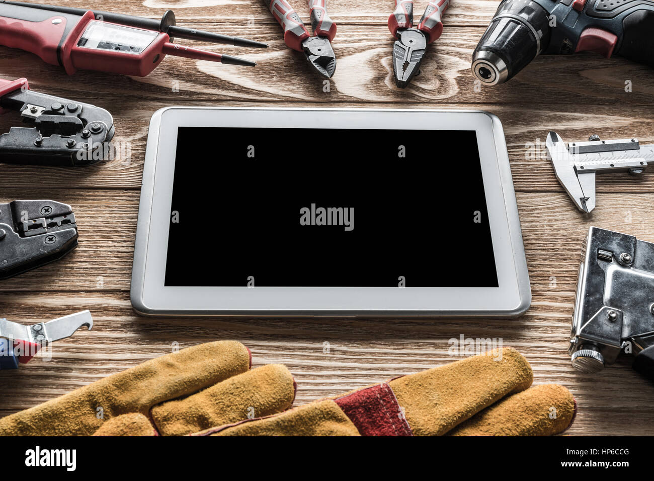 Variety of tools of builder and tablet pc on wooden texture table Stock ...