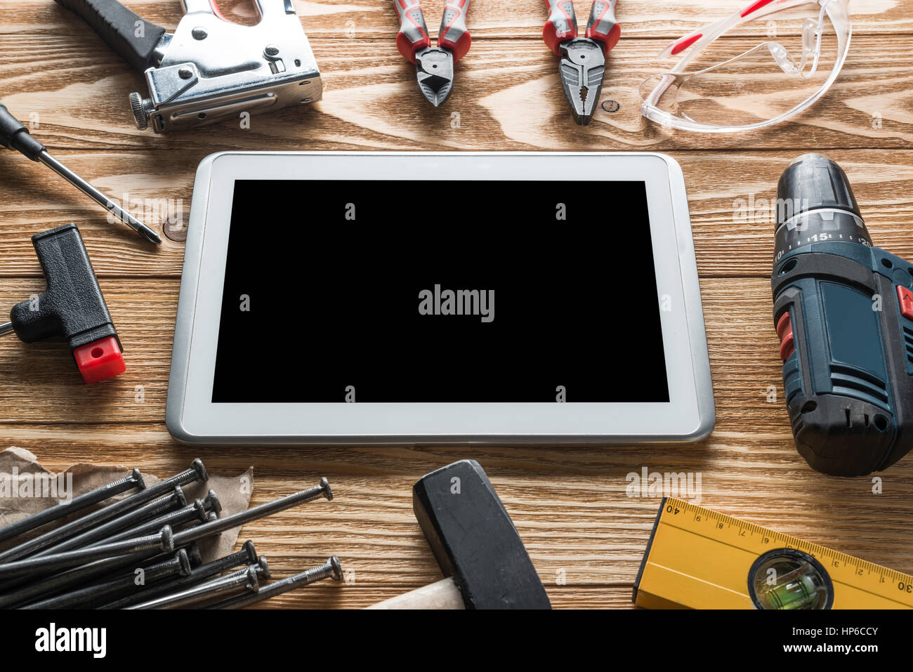 Variety of tools of builder and tablet pc on wooden texture table Stock ...