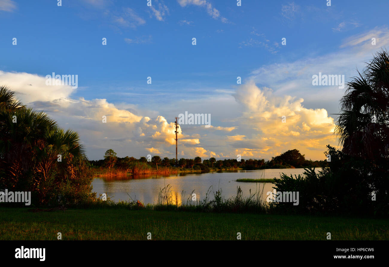 Evening orange glow on clouds above lake. Monument Lake Campground and ...