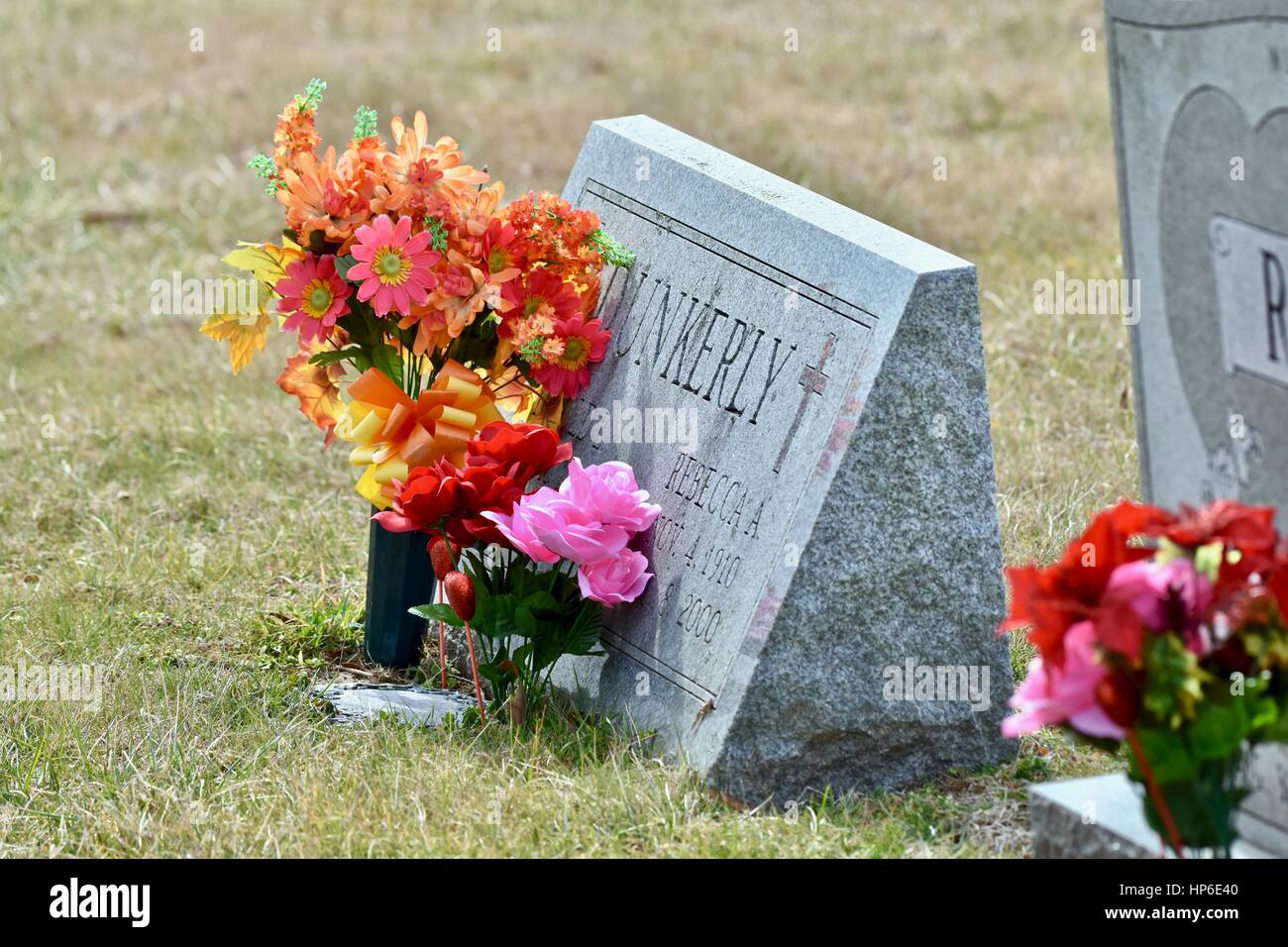 Tombstone at a small cemetery with remembrance left behind Stock Photo ...