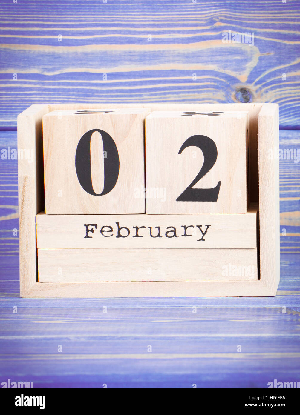 February 2nd. Date of 2 February on wooden cube calendar, purple board ...