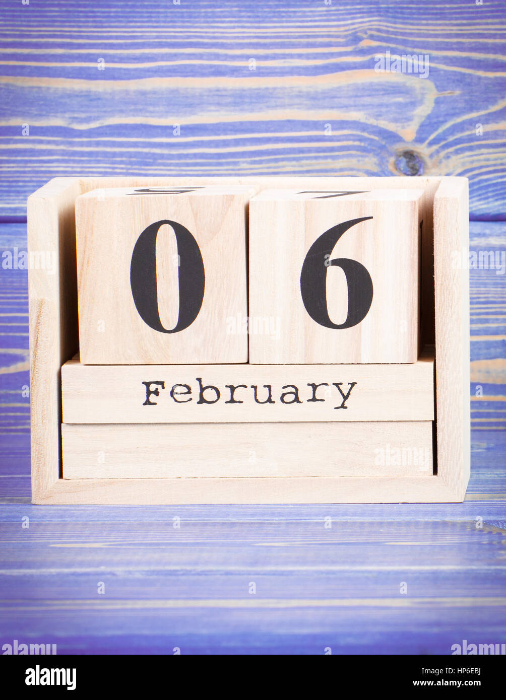 February 6th. Date of 6 February on wooden cube calendar, purple board ...