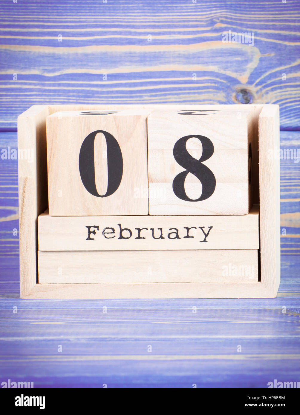 February 8th. Date of 8 February on wooden cube calendar, purple board ...