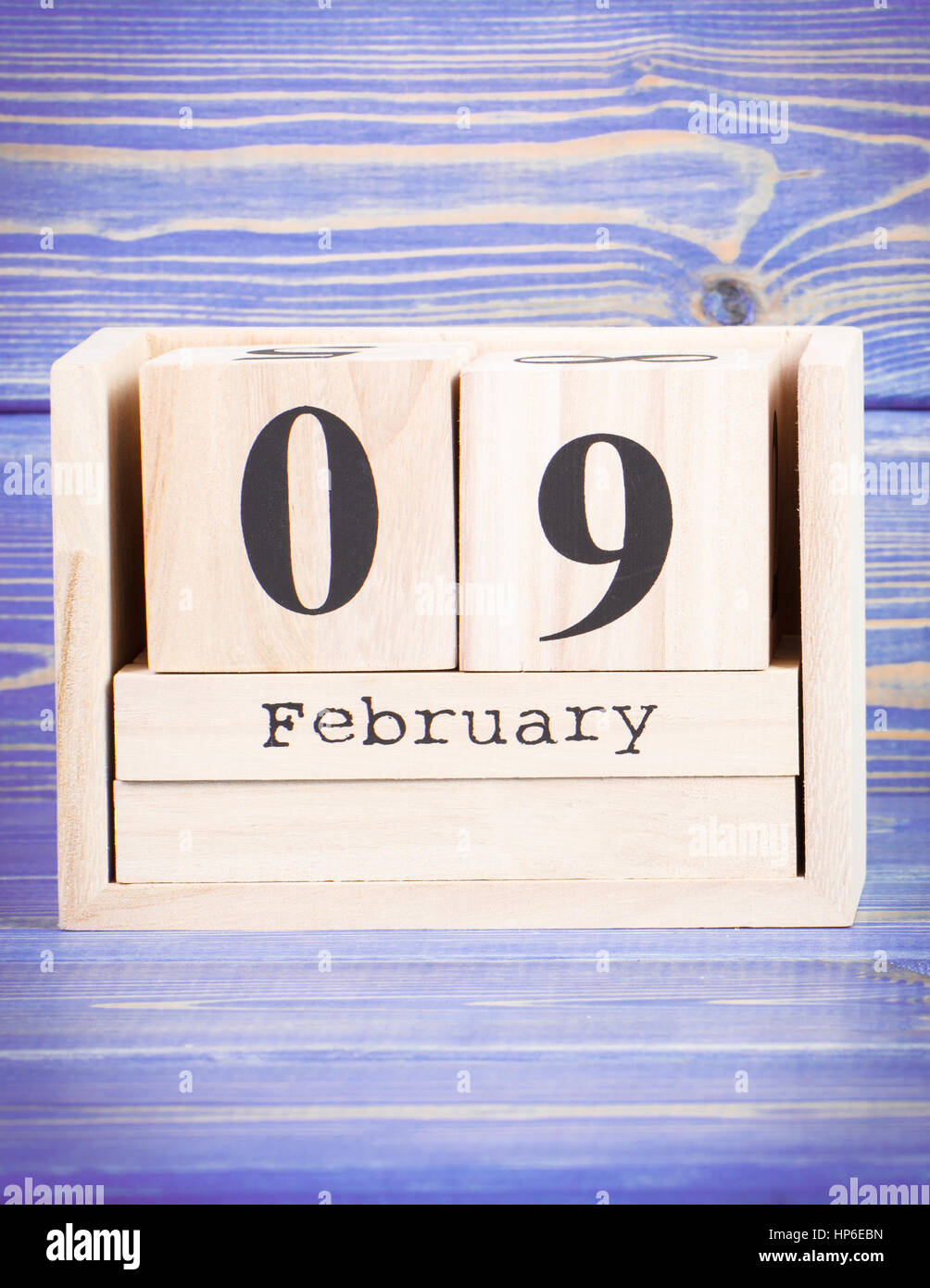 February 9th. Date of 9 February on wooden cube calendar, purple board ...