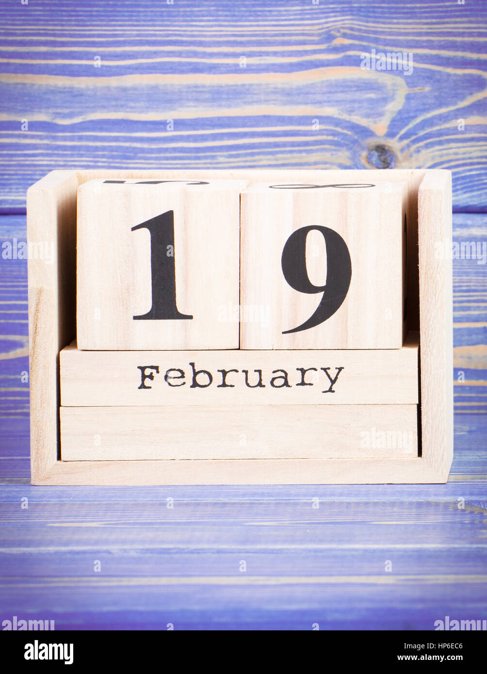February 19th. Date of 19 February on wooden cube calendar, purple ...