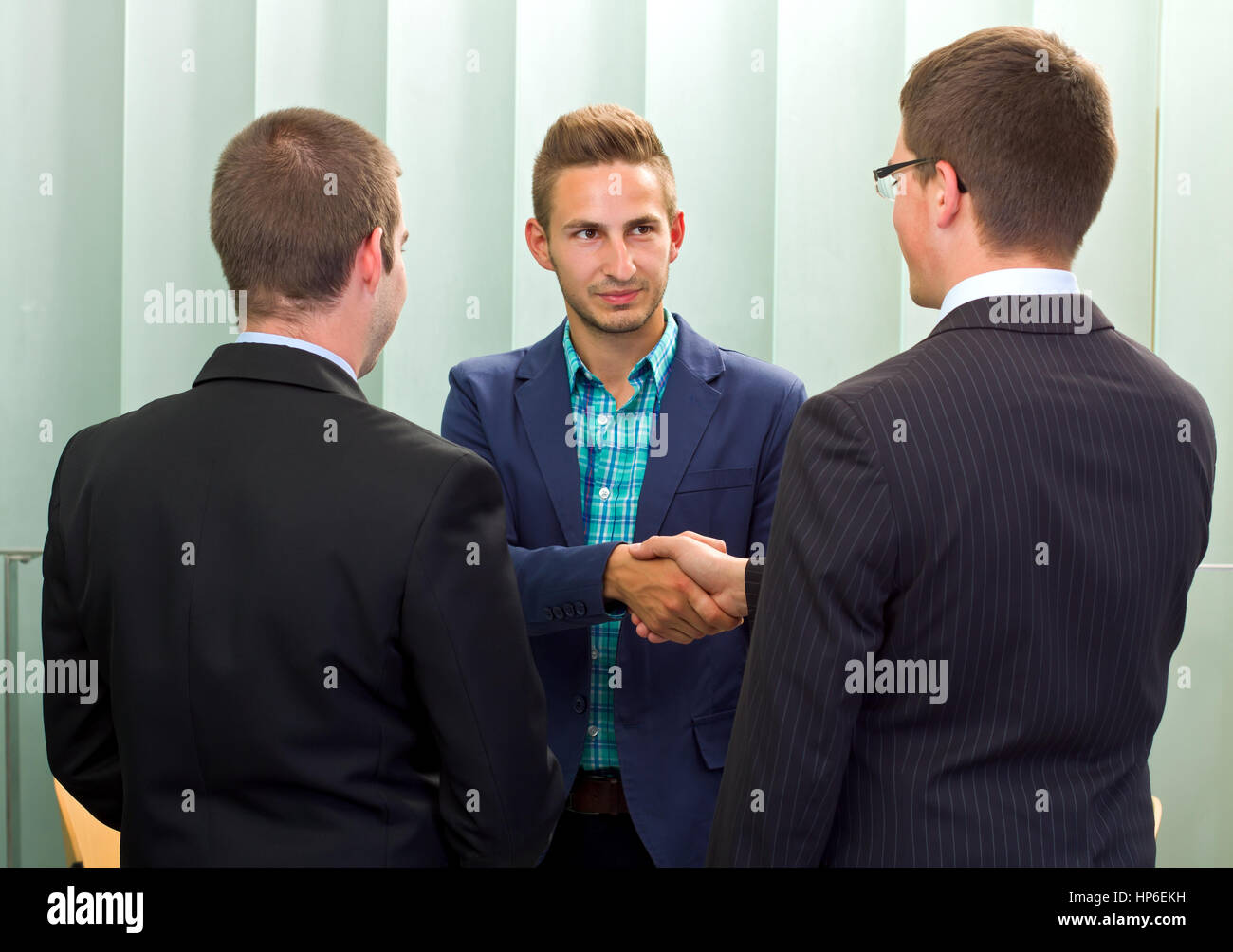 Confident businessman talking with his client in the office Stock Photo ...