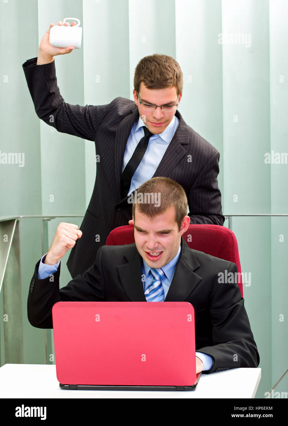 Angry and frustrated worker behind his boss Stock Photo - Alamy