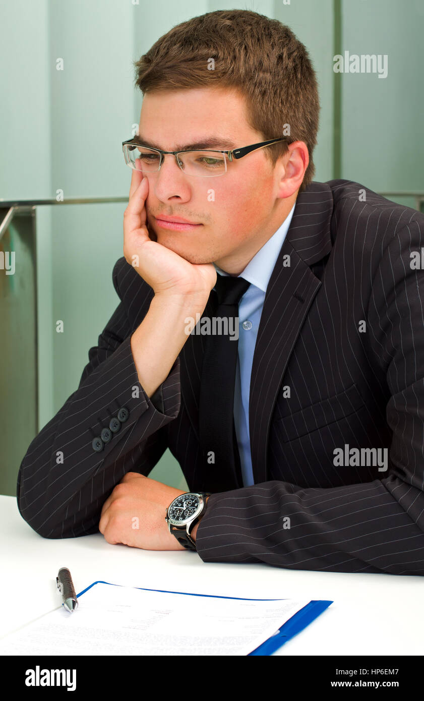 Tired and overworked businessman sitting at her table Stock Photo - Alamy