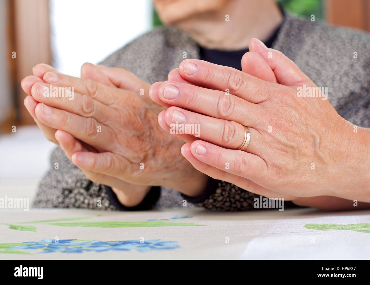 Picture of a doctor and a patient hand praying together Stock Photo - Alamy