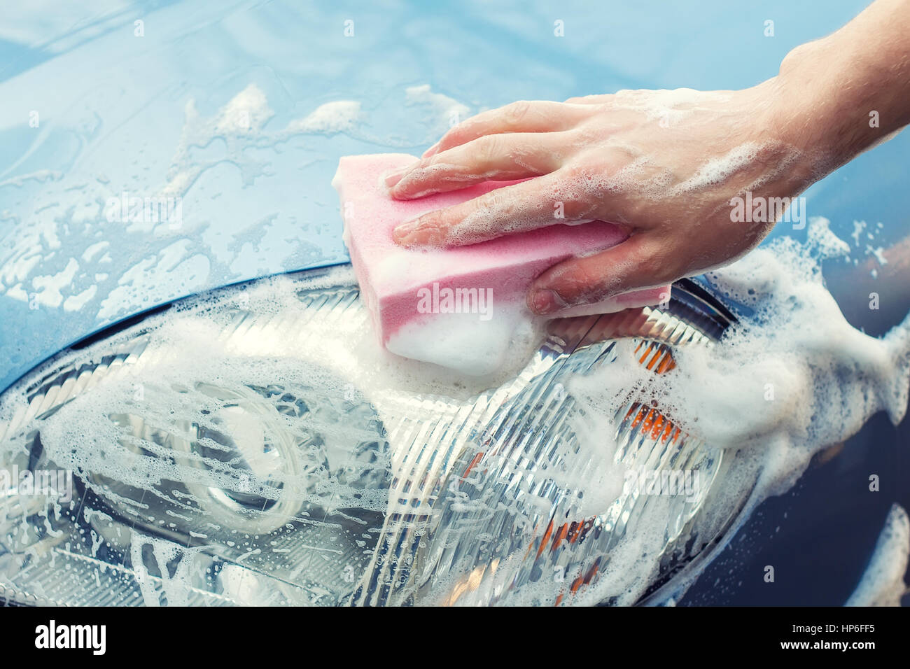 Washing the car by hand with soapy sponge. Cleaning the car. Car care ...
