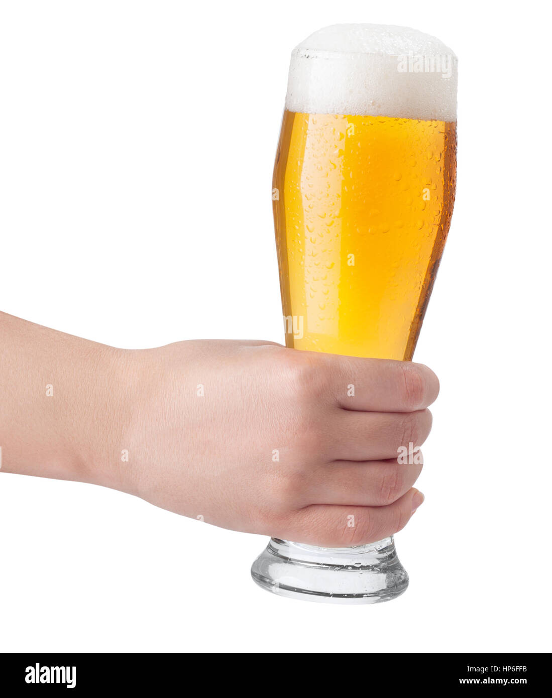 Closeup of female hand holding up a glass of beer on white background ...