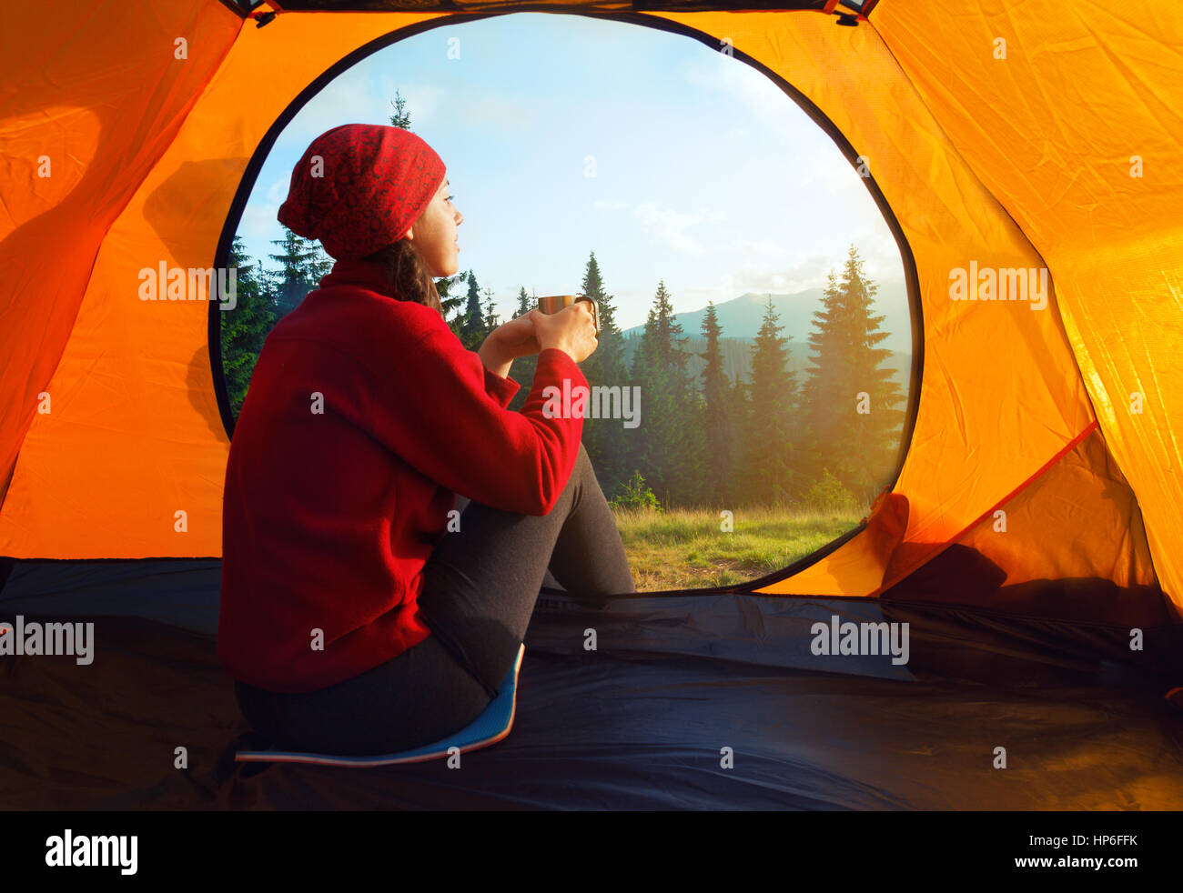 View from inside a tent on mountains landscape. Camping concept. Sunset ...